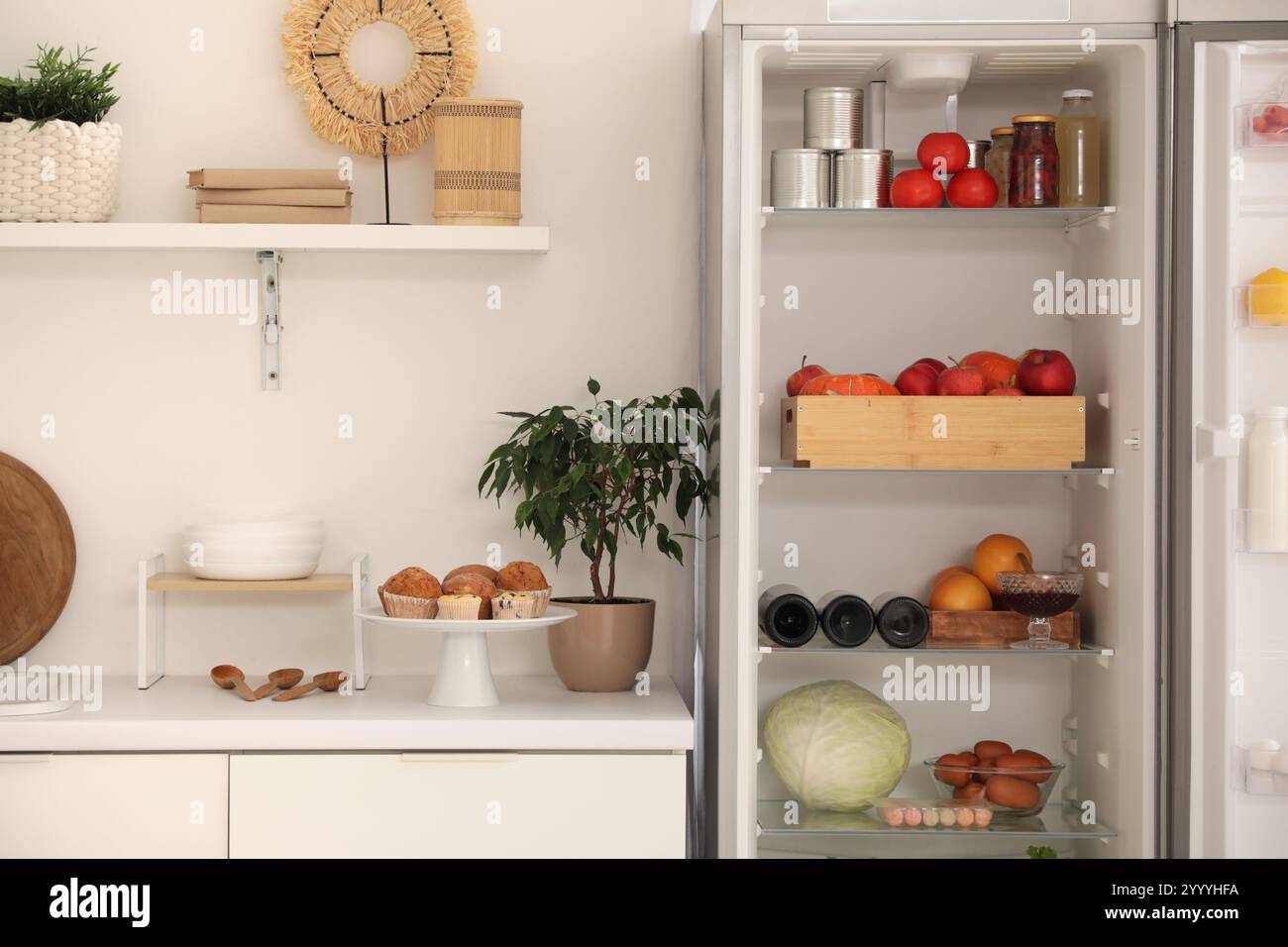 Open fridge full of different food in light kitchen Stock Photo - Alamy