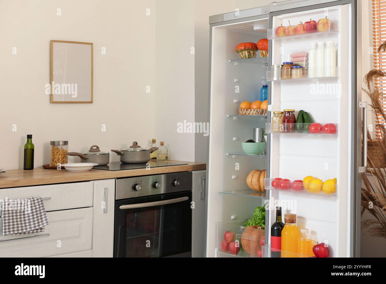 Open fridge full of fresh food in light kitchen Stock Photo - Alamy