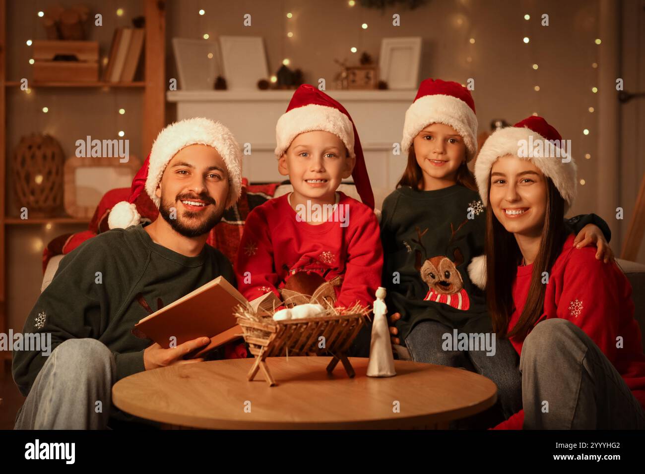 Happy family reading Christmas story at home in evening Stock Photo - Alamy