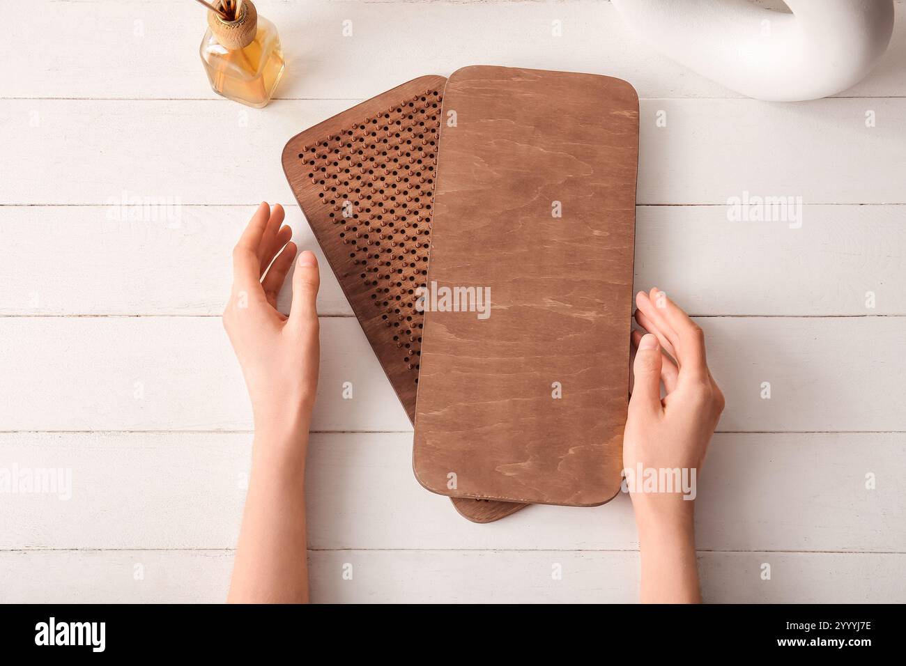 Female hands with Sadhu boards on white wooden background Stock Photo ...