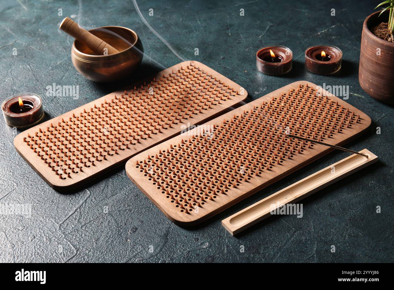 Sadhu boards with aroma candles, stick and Tibetan singing bowl on dark ...