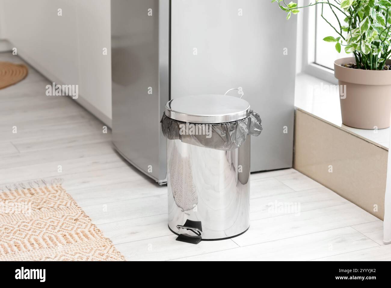 Trash bin with foot pedal in kitchen Stock Photo - Alamy