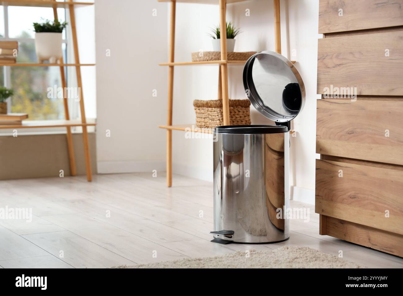 Trash bin with foot pedal in living room Stock Photo - Alamy
