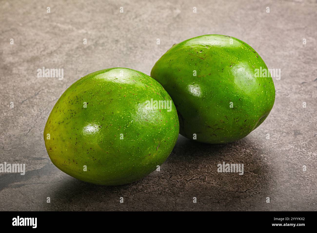 Two ripe green exotic avocado whole fruit Stock Photo - Alamy