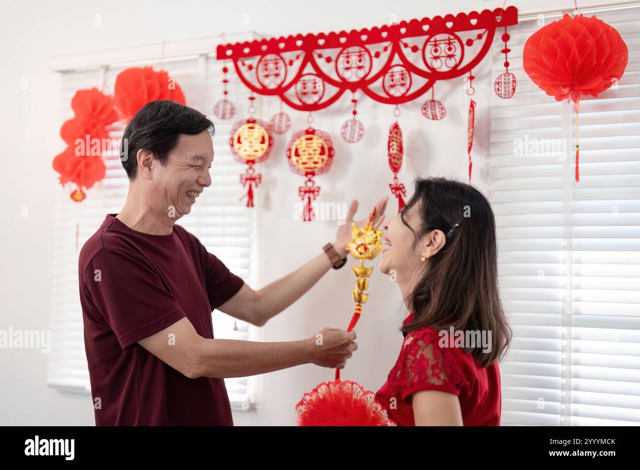 Elderly couple celebrates chinese new year at home festive decorations ...