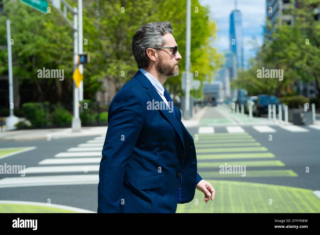 Photo of business man in suits walking outdoor through city street in ...