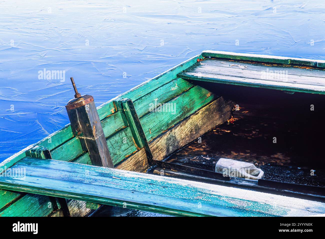 Old wooden rowing boat in the ice on the lake Stock Photo - Alamy