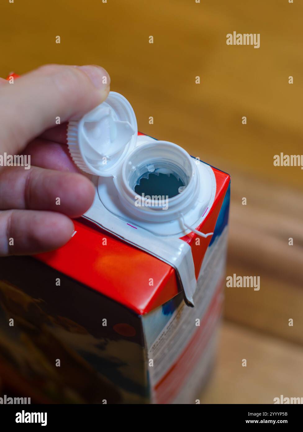 new screw cap a milk Carton with Close-Up View of Hand and Cap Design ...