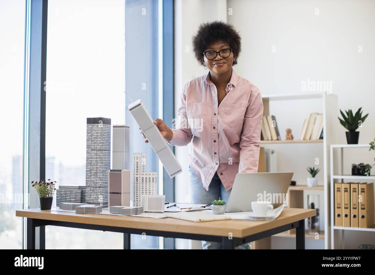 African American female architect in casual attire working on city ...
