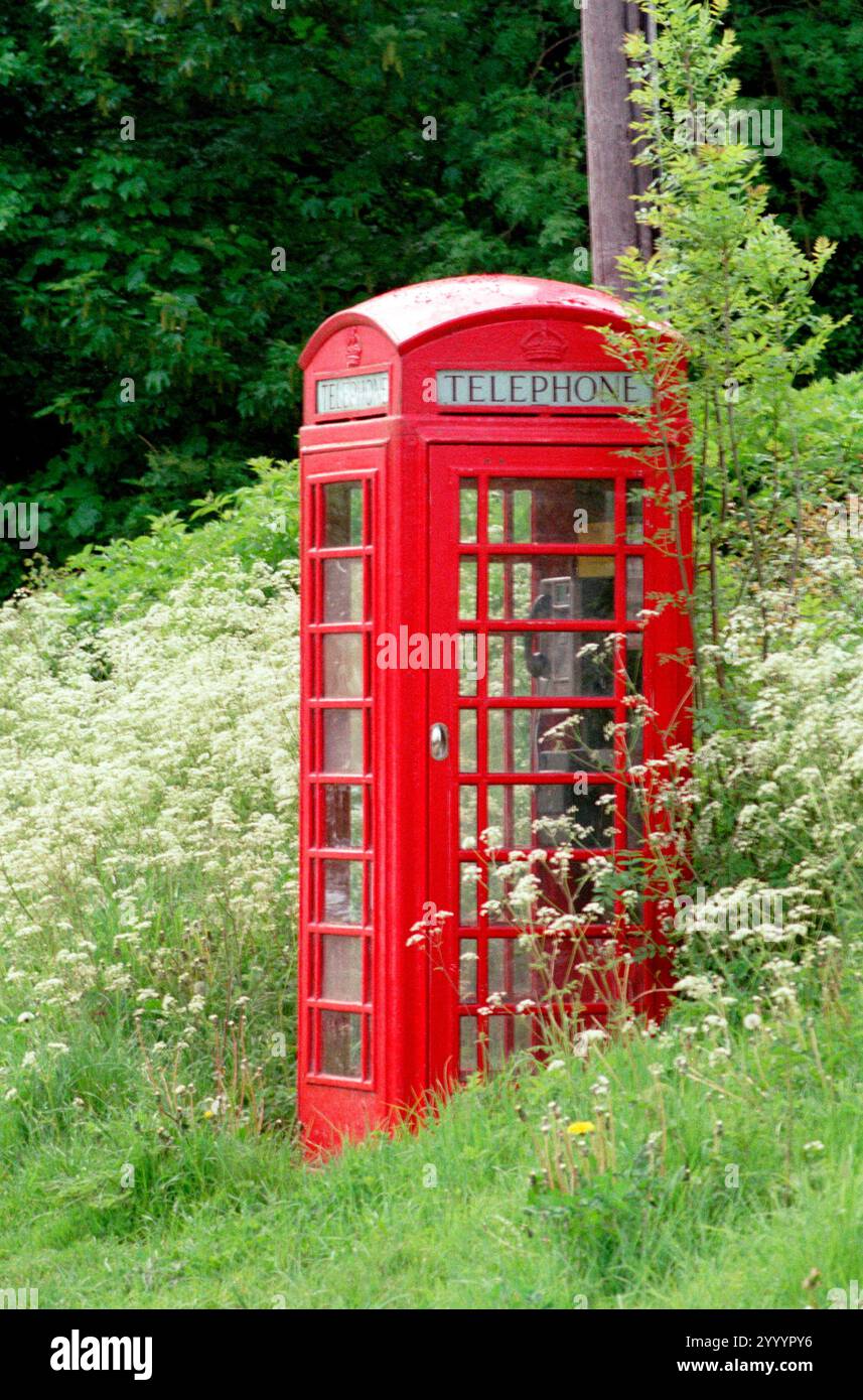 May 1995: A traditional red telephone box in rural countryside. These ...