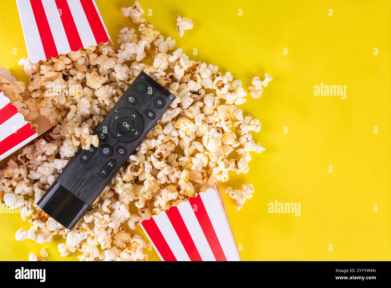 Paper bowl buckets of popcorn with TV remote on colorful bright ...