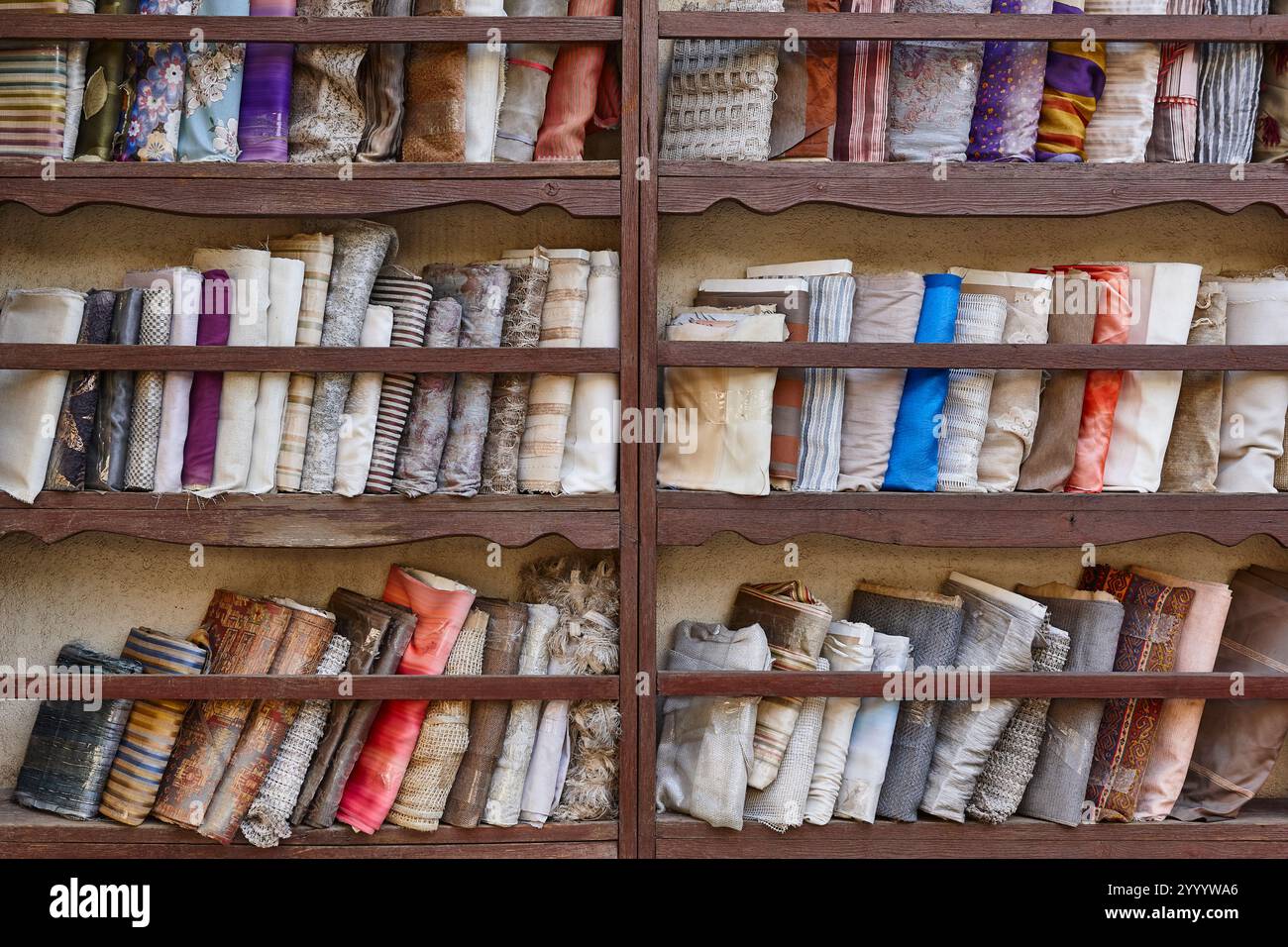 Different kinds of fabric. Textile storage on a wooden cabinet Stock ...