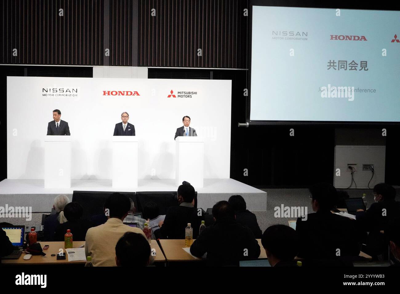 On podium from left, Nissan Chief Executive Makoto Uchida, Honda Chief ...