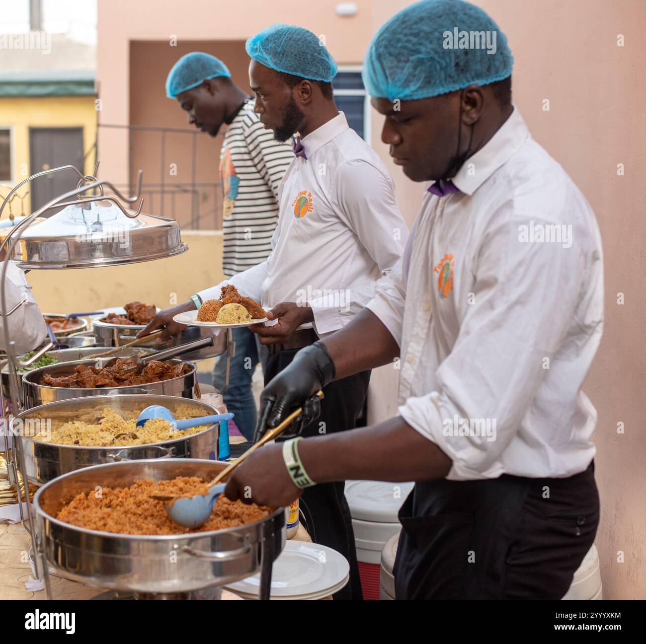 Lagos, Nigeria - December 20, 2024. Delighting in tradition, a waiter ...
