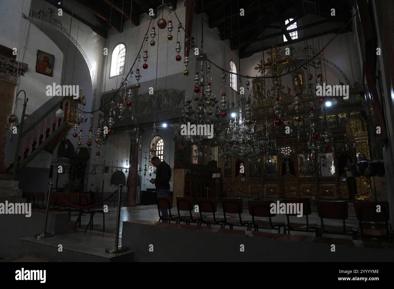 A worker walks in the Church of the Nativity, where Christians believe ...