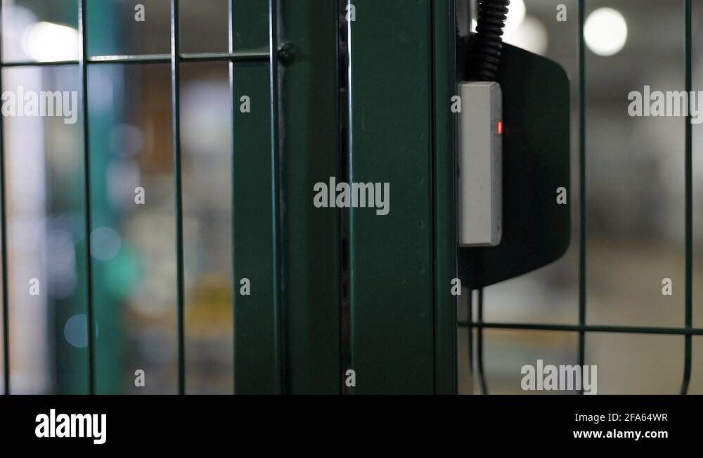 manufacturing engineer is opening electromagnetic lock of door in a ...