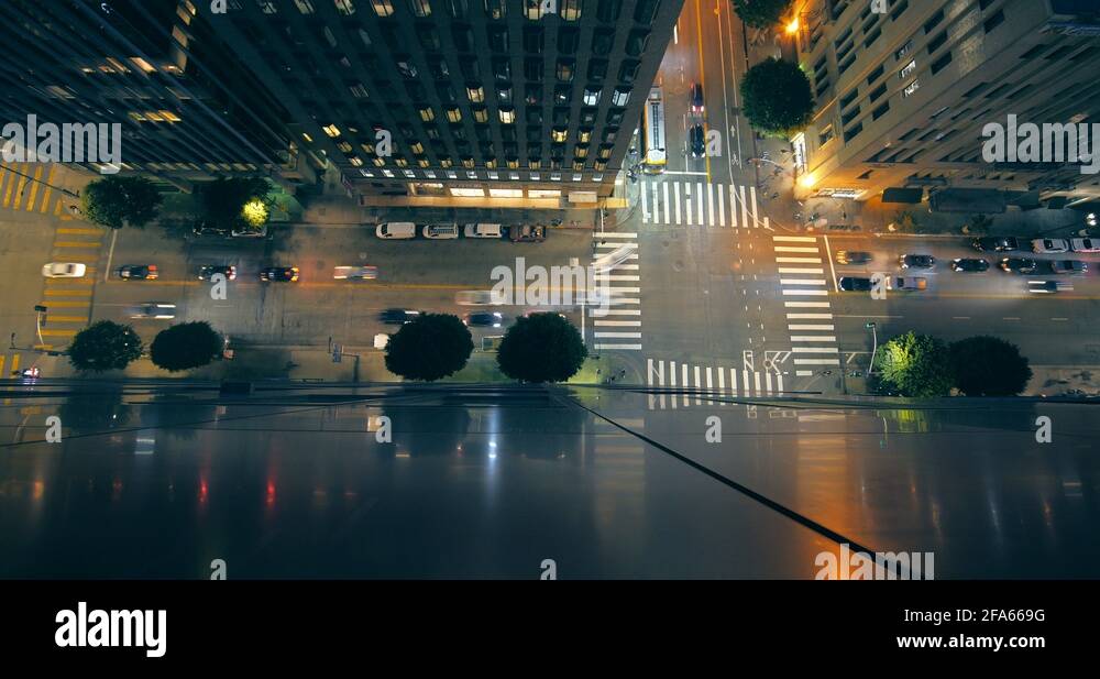 Traffic and street intersection reflecting on metal building wall in ...