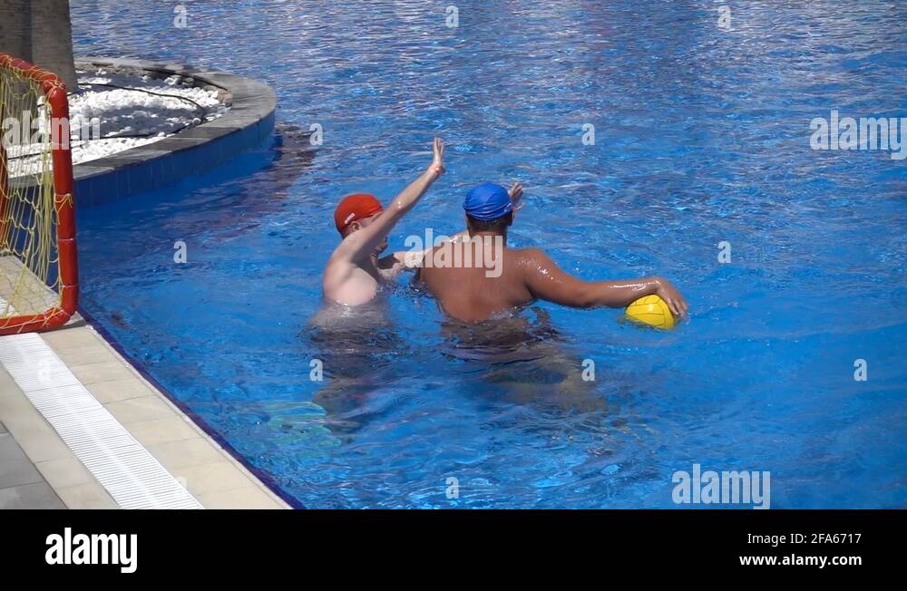 Group of people play water polo in pool. Active holiday in the Turkish ...