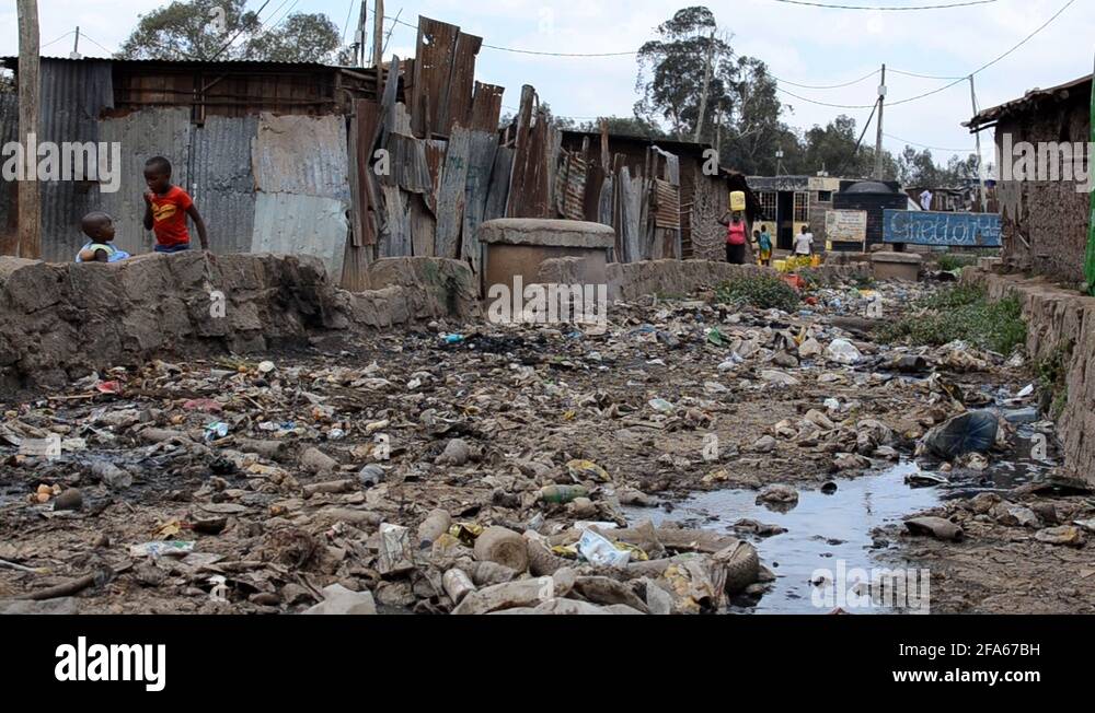Sewage water with garbage and people walking by in Kibera Slum, Nairobi ...