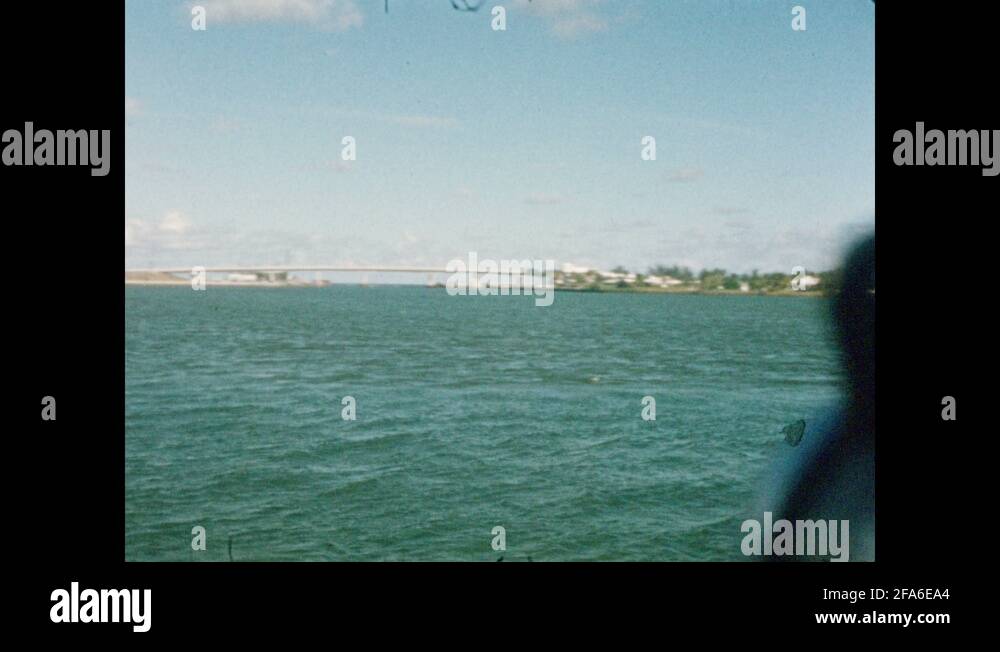 1950s: UNITED STATES: bridge across waterway. White clouds in sky ...