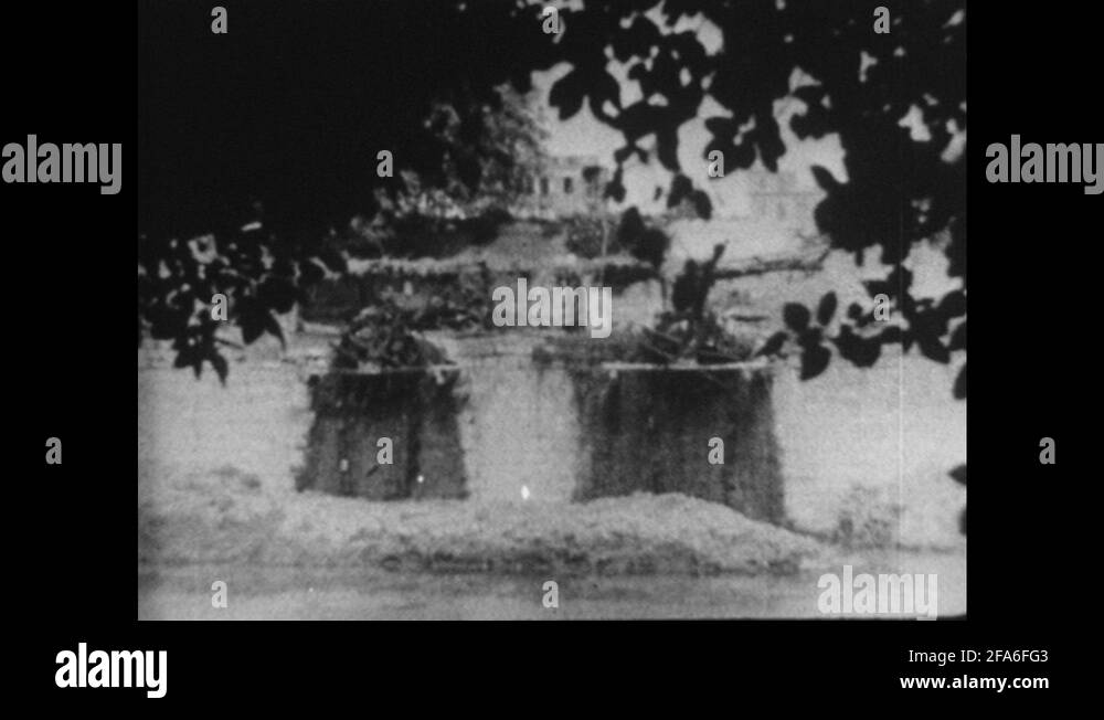 1930s: Intertitle. Two water wheels by a river. Water wheels rotate ...