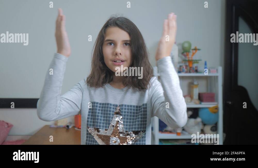 hide and seek. little girl covered her eyes face with her hands peek a ...