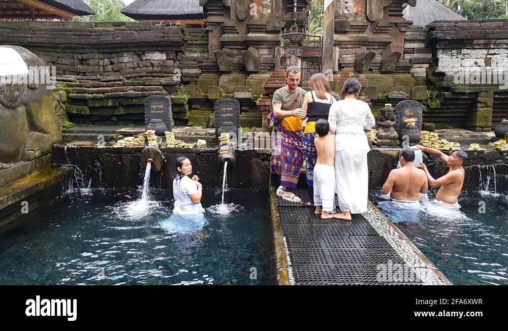 People taking bath under holy water in the tirta empul temple. Bali ...