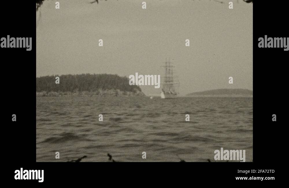 1920s: View of two and three masted ships on the water from yacht ...