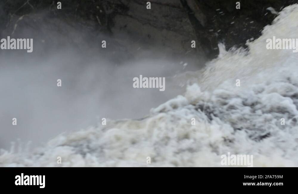 One view of a water falling over the lip of a waterfall in a normal ...