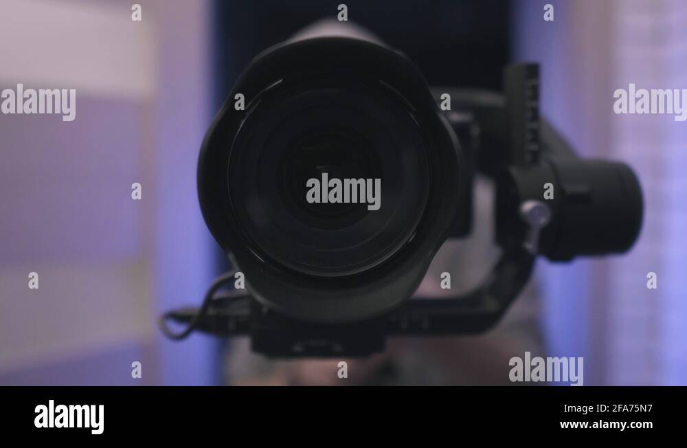 Filmmaker operates handheld gimbal with camera. 4K UHD cinematic ...
