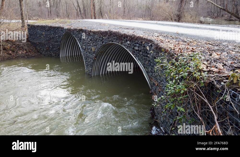 Backing away from corrugated culverts held in place by gabions Stock ...