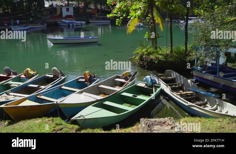 On a vacation, with mini row boats docked at the calm port waters of ...