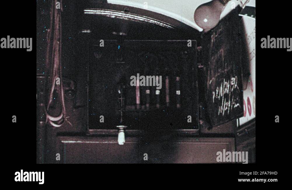 1950s: Night. Conductor opens box and turns switch. Lights come on ...