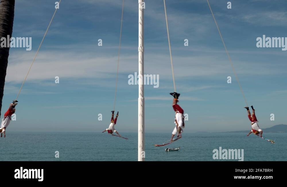 Flying Pole Dancers slowly make an upside-down descent to the ground ...
