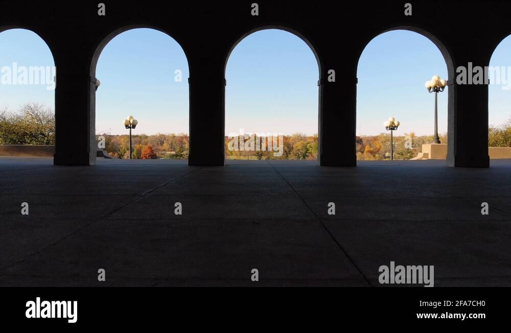 Drone passing through arches in old building exposing background view ...
