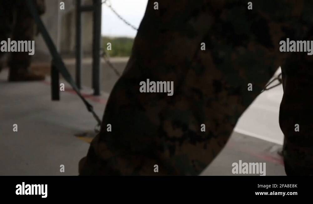 Marines practice their fast-roping skills at the Camp Hansen rappel ...