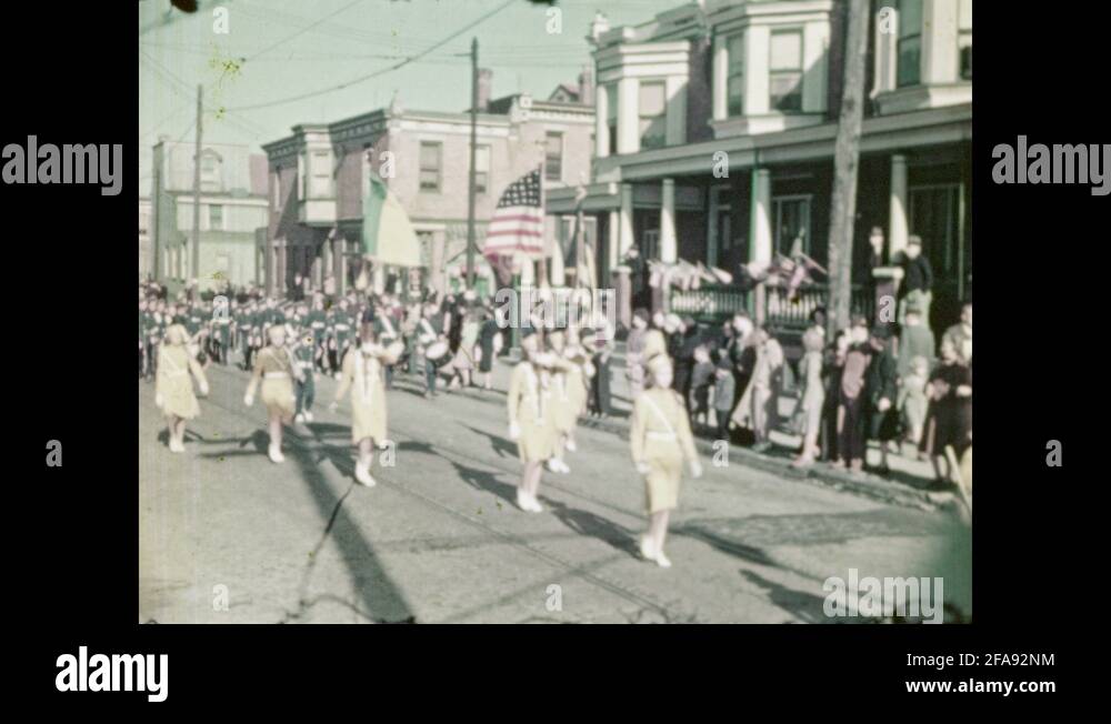 1930s: Women in uniform carry flags in parade. Men in military uniforms ...