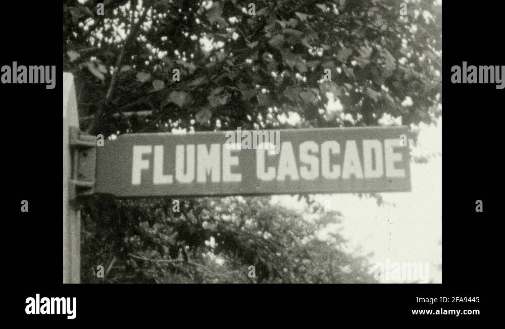 1920s: UNITED STATES: Flume Cascade sign. Girl holds man's hand. Family ...