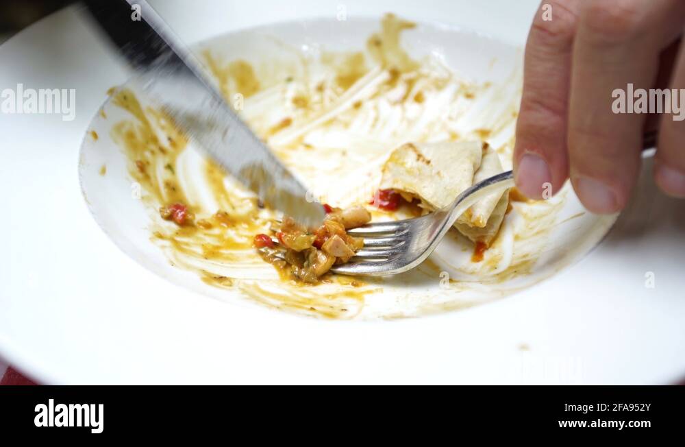 Man almost finished eating his lunch. Empty dirty after food plate ...