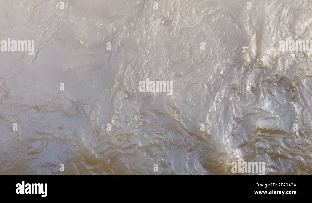 Strong water current and whirlpool caused by water entering a floodgate ...