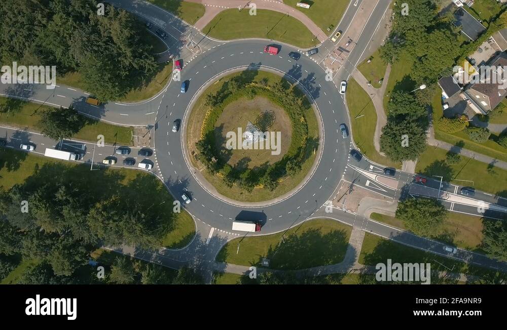 An aerial top view from a dutch roundabout (drone follows the cars ...