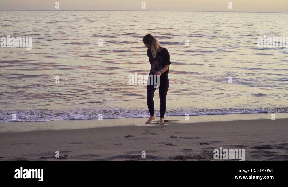 Girl running away from waves on a beach during golden hour on Malibu ...