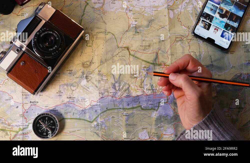 A top-down view of somebody planning a trip with a map in 4K Stock ...
