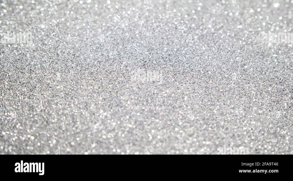 Silver glitter texture surface rotating. Close up 4k backdrop footage ...