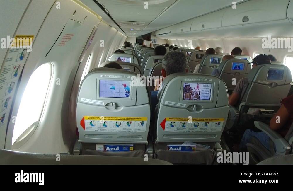 Inside of a plane from behind showing screens of seats Stock Video ...