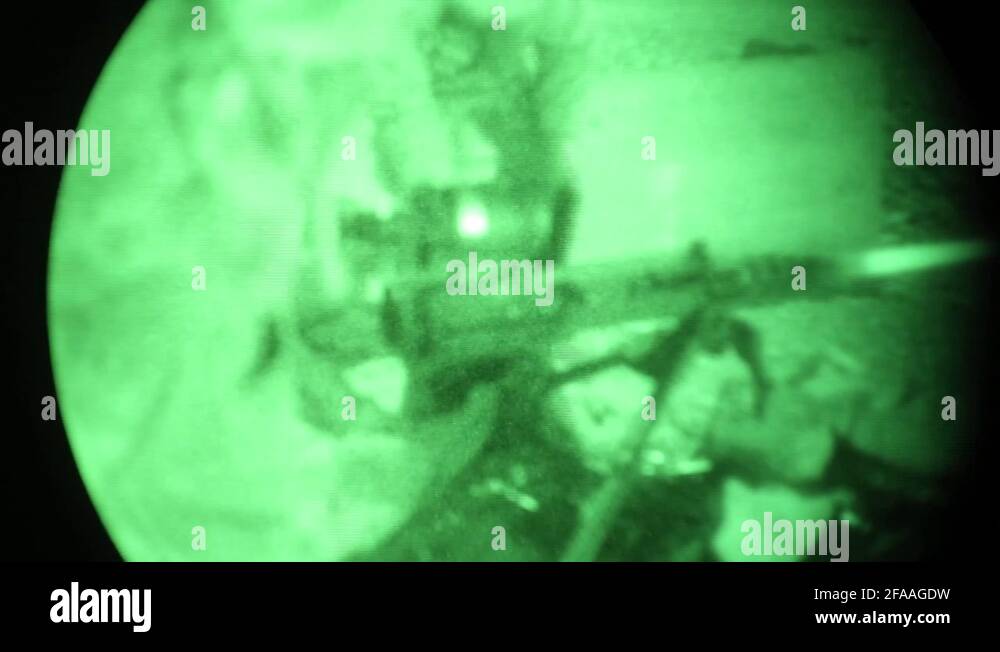 Night vision imagery of soldier loading machine gun during live fire ...