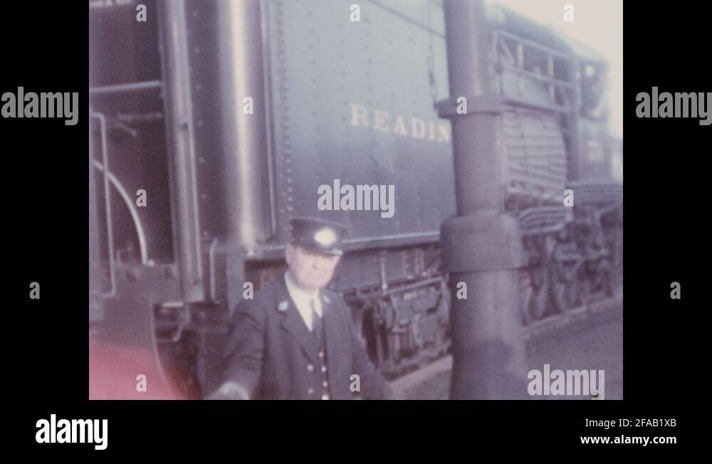 1930s: UNITED STATES: train conductor waves red flag by train. Side ...