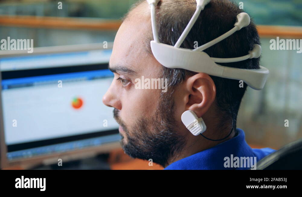 An engineer wearing special Brainwave Scanning sensors on a head, back ...