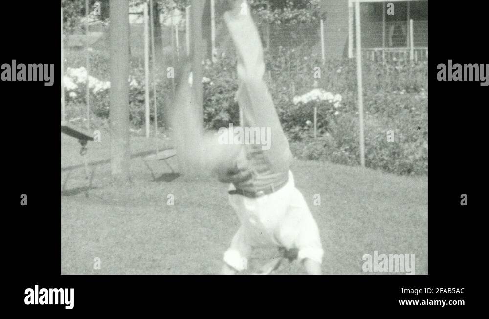 1920s: Man does handstand. Man does front flip. Man tries to push woman ...