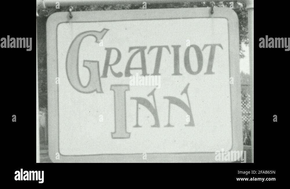 1920s: Sign for Gratiot Inn. Woman walks down sidewalk. Street. Street ...